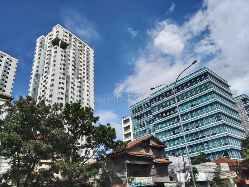 Portrait of a Tall Building in the Middle of the City from the Bottom ...