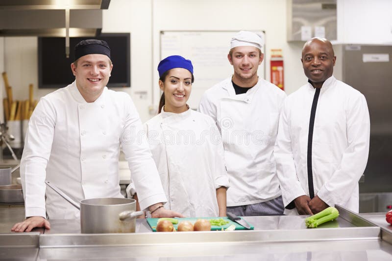 Teacher Helping Students Training To Work in Catering Stock Photo ...