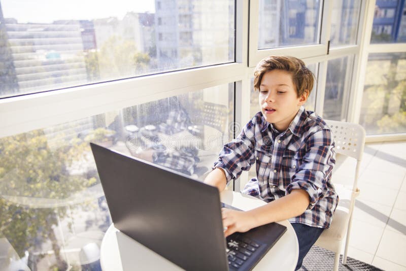 Teen Boy with Laptop Computer by Wall Stock Photo - Image of wireless ...