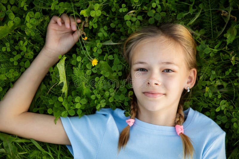 Portrait of a Teenage Girl Lying on the Grass Stock Photo - Image of ... Portrait of a Teenage Girl Lying on the Grass Stock Photo - Image of ...