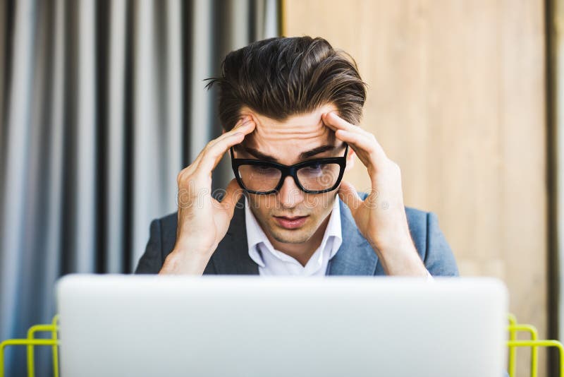Portrait of Thinking Man Using Laptop Computer at Home. Stock Image ...