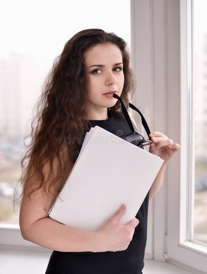Portrait of a Thoughtful Businesswoman Holding Papers Stock Image ... Portrait of a Thoughtful Businesswoman Holding Papers Stock Image ...