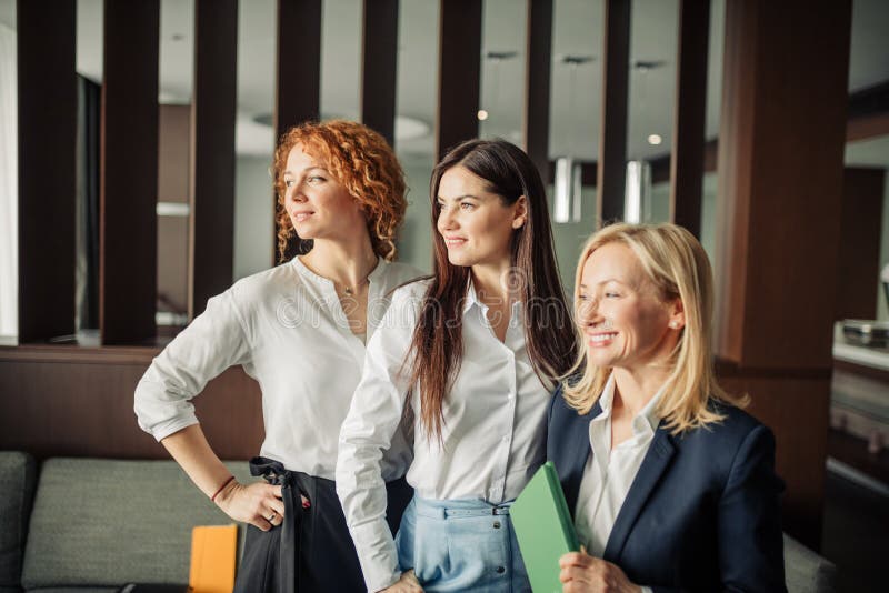 Portrait Of Three Caucasian Business Women In Formal Wear In A Hotel