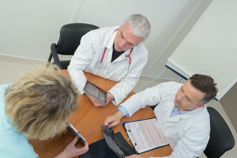 Portrait three doctors stock image. Image of thumbs - 257188237