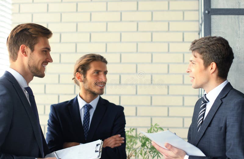 Portrait of Three Partners Discussing Ideas at Meeting. Stock Image ...