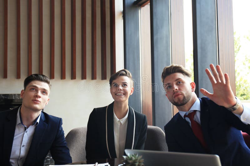 Portrait of Three Partners Discussing Ideas at Meeting. Stock Photo ...