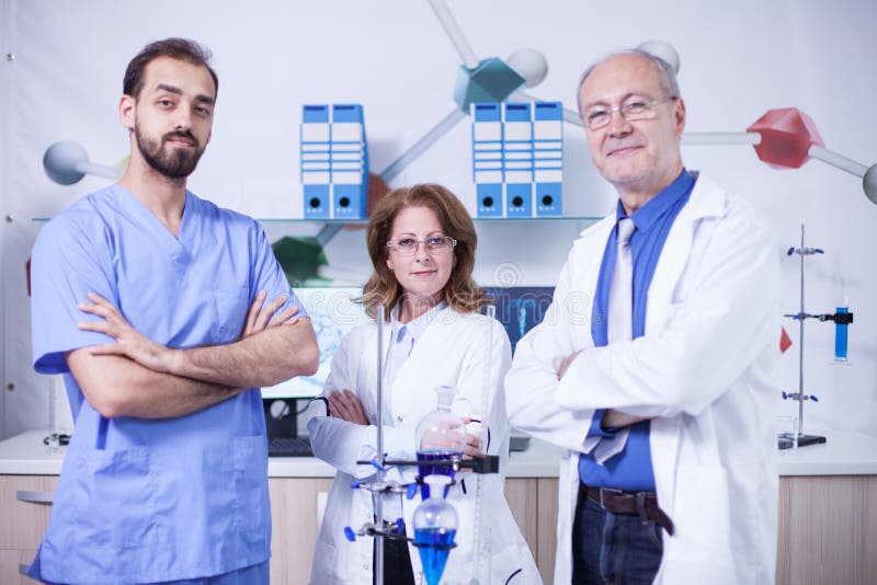 Portrait of Three Scientist Dressed in Their Uniform in a Laboratory ...