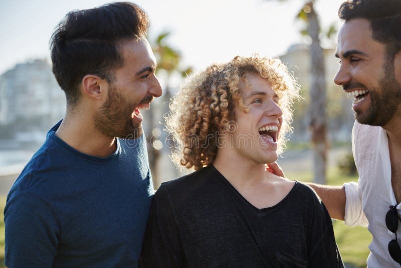 Three Young Men Talking Together Outside Laughing Stock Photo - Image ... Three Young Men Talking Together Outside Laughing Stock Photo - Image ...
