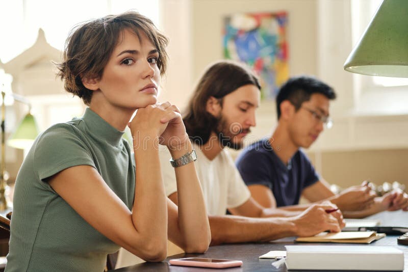 Young Thoughtful Female Student Thinking about Study Project in Library ...