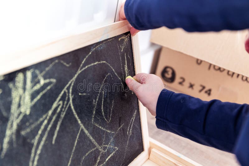 A Portrait of a Toddler Scribbling, Drawing or Doodling a Bit on a ...