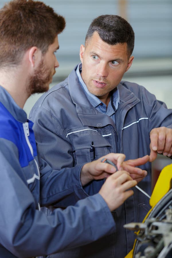 Trainee mechanic at work stock photo. Image of trainer - 132188870