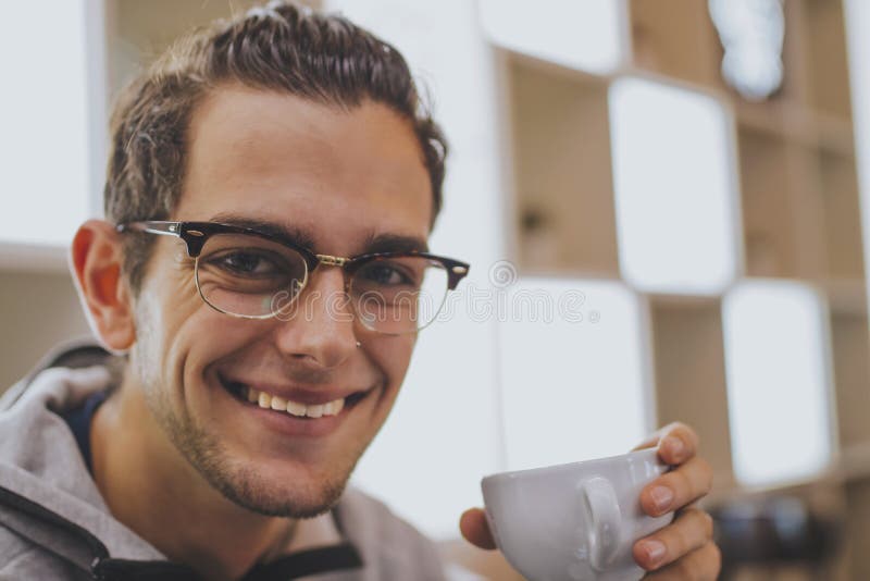 Young man taking coffee stock photo. Image of fashion - 135850240