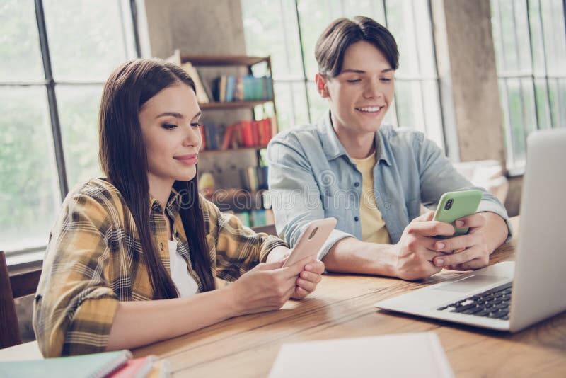 Portrait of Two Attractive Focused Group Mates Learners Using Gadgets ...