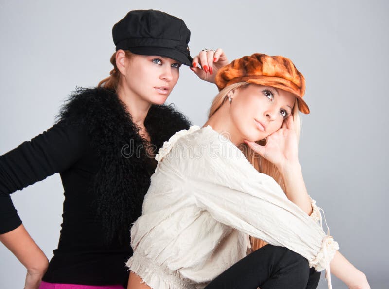 Portrait of Two Beautiful Women Wearing Caps Stock Image - Image of ...