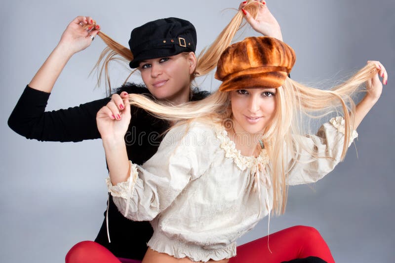 Portrait of Two Beautiful Women Wearing Caps Stock Image - Image of ...