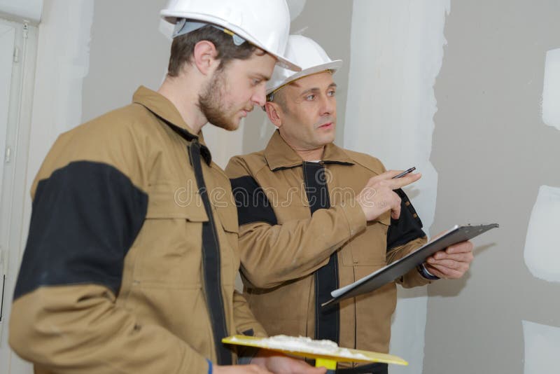 Portrait Two Builders Talking Indoors Stock Photo - Image of builder ...