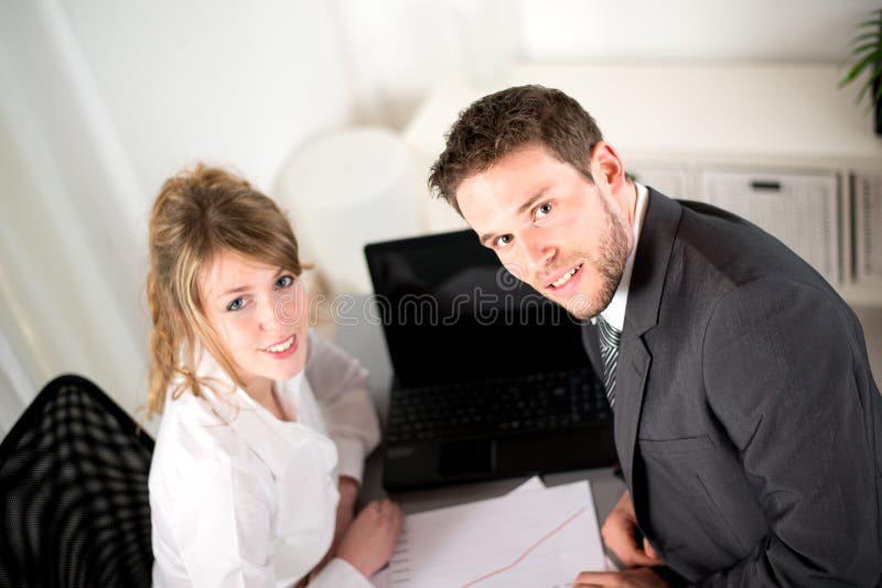 Portrait of Two Business People Working Together in Office with ...