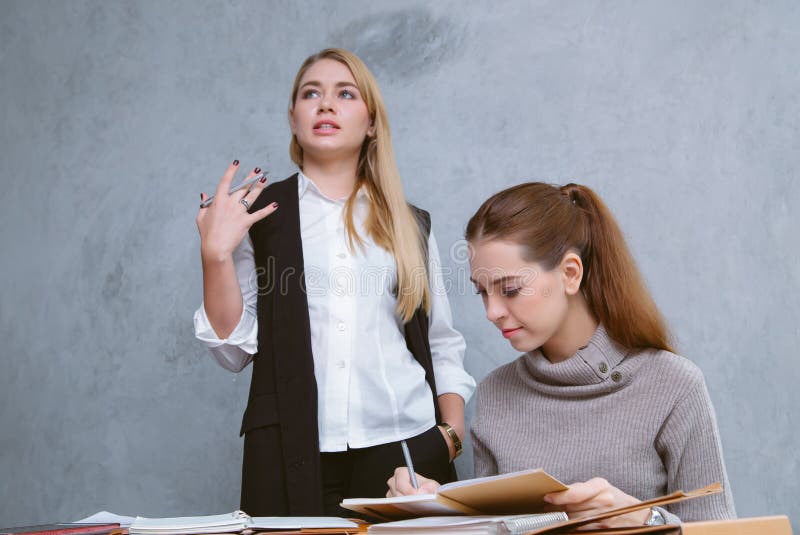 Portrait Of Two Businesswomen Discussing New Project In Modern Office