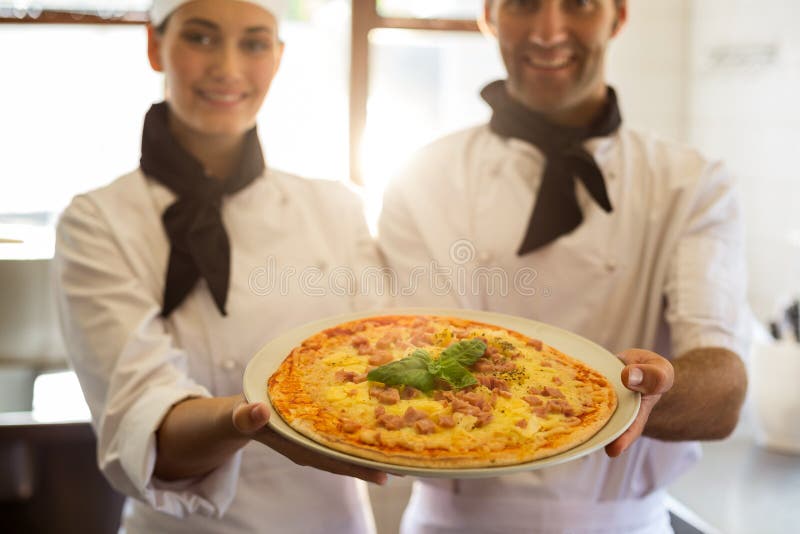 Portrait of Two Chef Presenting a Pizza Stock Image - Image of plate ...
