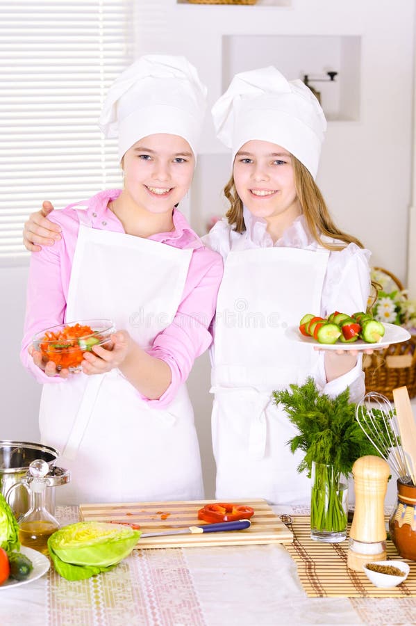 Close-up Portrait of Two Cute Girls Cooking Stock Photo - Image of ...
