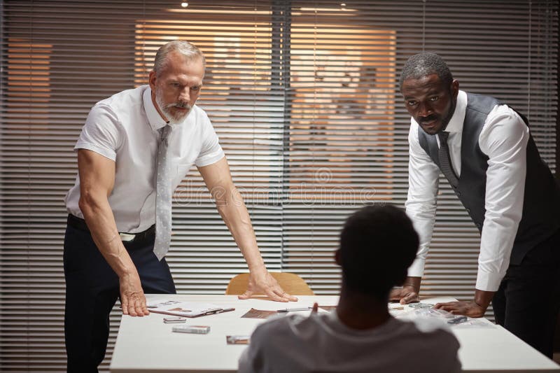 Two Detectives Interrogating Suspect in Criminal Case Stock Photo ...