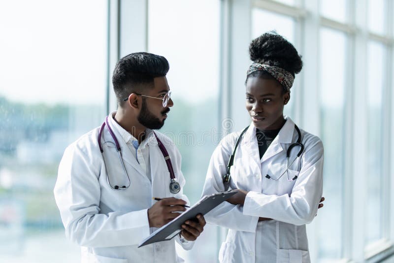 Portrait of Two Doctors Looking at a Document in an Office Stock Image ...