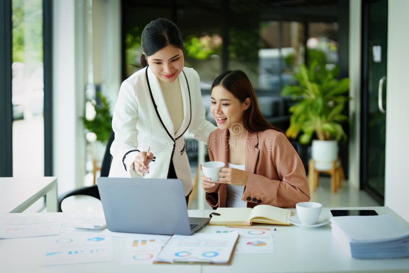 Portrait of Two Female Employees Using Computers during Work. Stock ...
