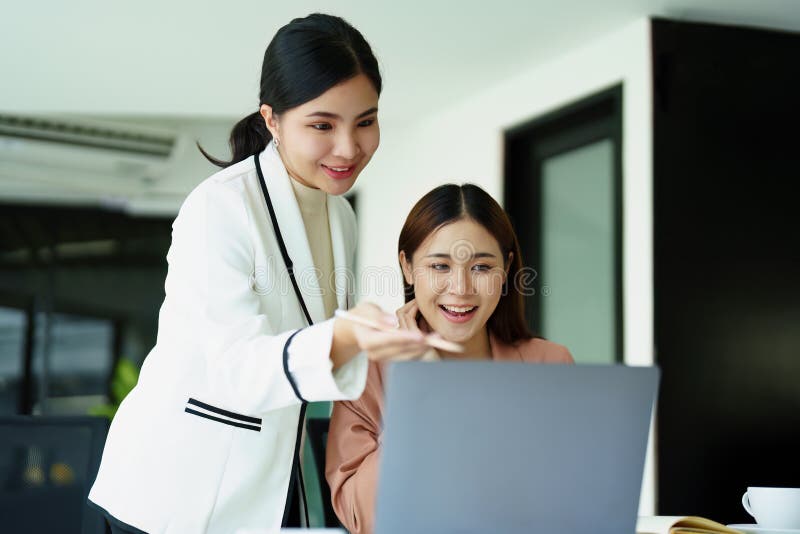 Portrait of Two Female Employees Using Computers during Work. Stock ...