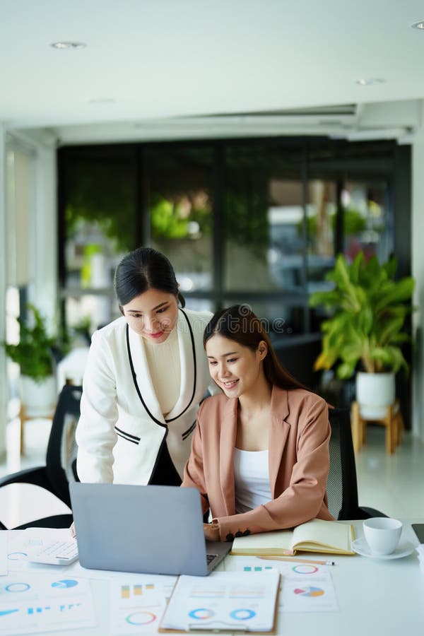 Portrait of Two Female Employees Using Computers during Work. Stock ...