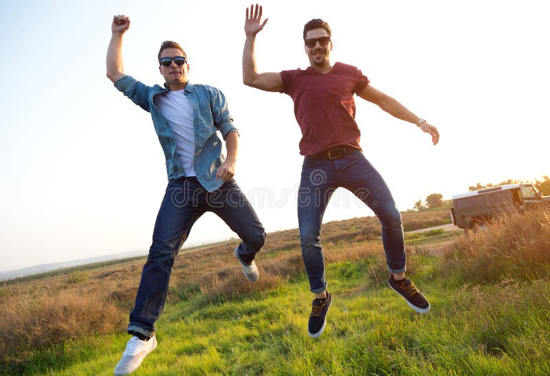 Portrait of Two Friends Jumping in Field. Stock Photo - Image of shape ...