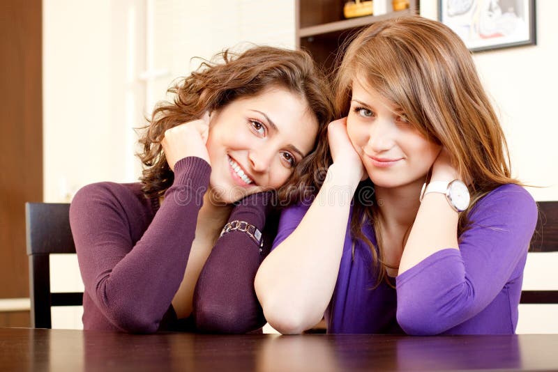 Portrait of Two Girls Sitting on a Kitchen Table Stock Image - Image of ...