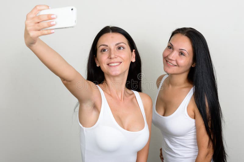 Portrait Of Two Happy Beautiful Women Taking Selfie Together Stock