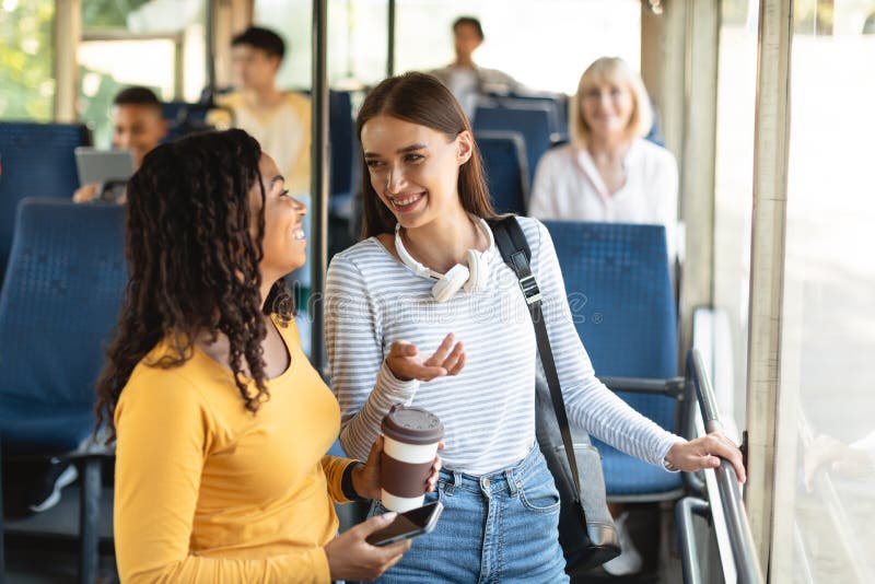 Beautiful Multiethnic Smiling Women Standing in Bus and Talking Stock ...