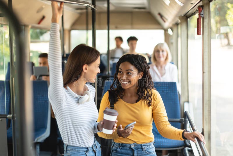 Beautiful Smiling Ladies Standing in Bus and Talking Stock Image ...