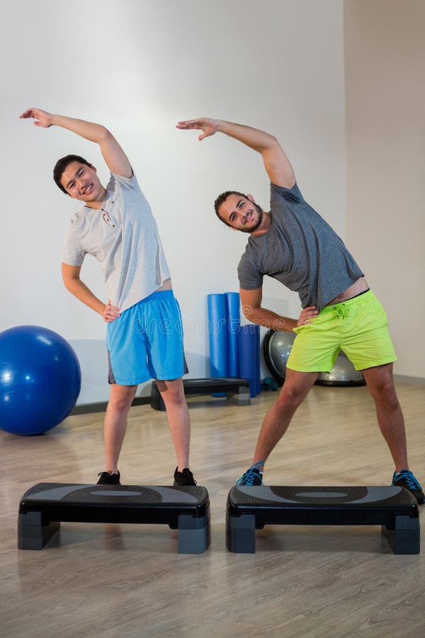 Portrait of Two Men Doing Aerobic Exercise with Stepper Stock Photo ...
