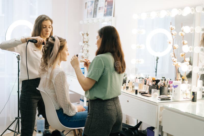 Portrait of Two Professional Make-up Artist Doing Makeover in Lighting ...