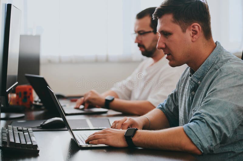 Portrait of Two Professional Male Programmers Working on Computer in ...