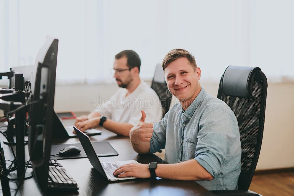 Portrait of Two Professional Male Programmers Working on Computer in Diverse Offices. Modern it ...