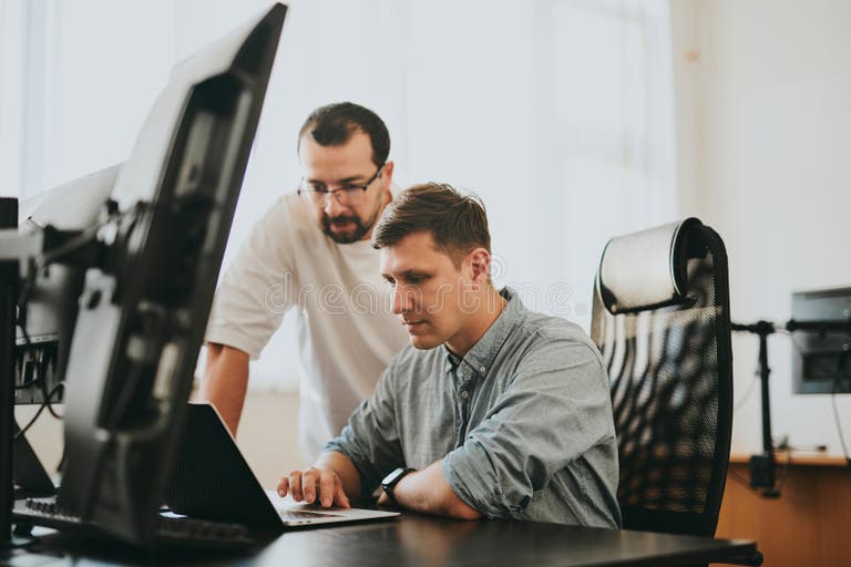 Portrait of Two Professional Male Programmers Working on Computer in Diverse Offices. Modern it ...