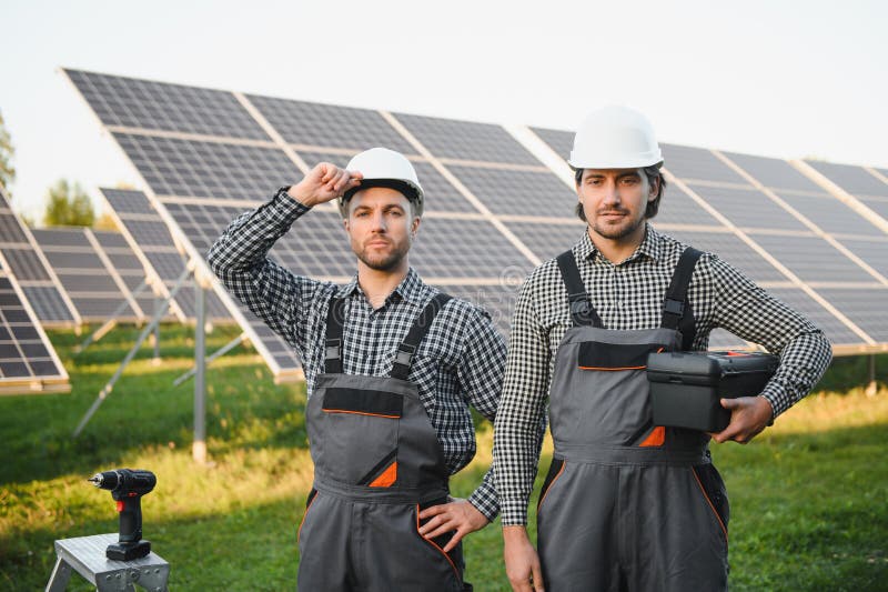 Portrait of Two Professional Workers in Uniform and Helmets Working in ...