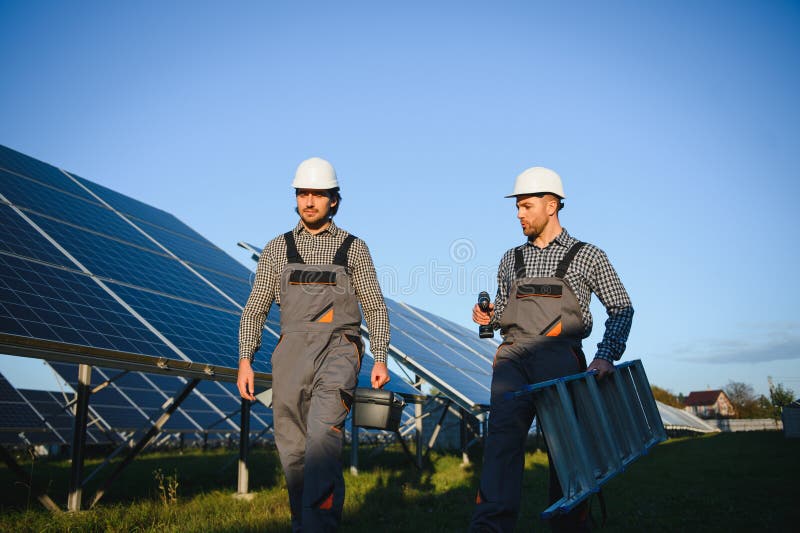 Portrait of Two Professional Workers in Uniform and Helmets Working in ...