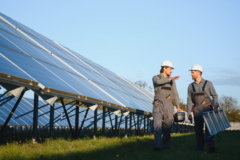 Portrait of Two Professional Workers in Uniform and Helmets Working in ...