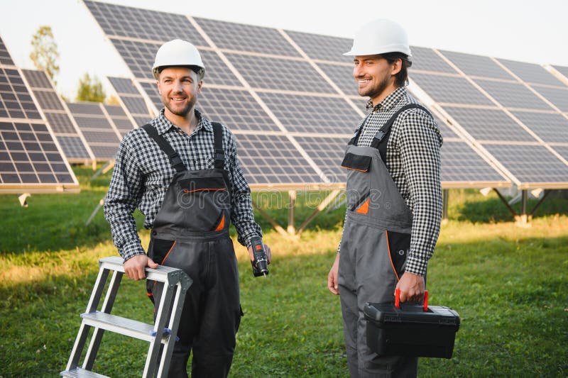 Portrait of Two Professional Workers in Uniform and Helmets Working in ...
