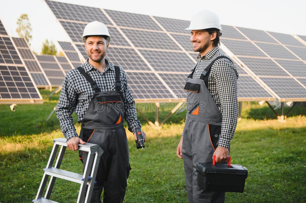 Portrait of Two Professional Workers in Uniform and Helmets Working in ...