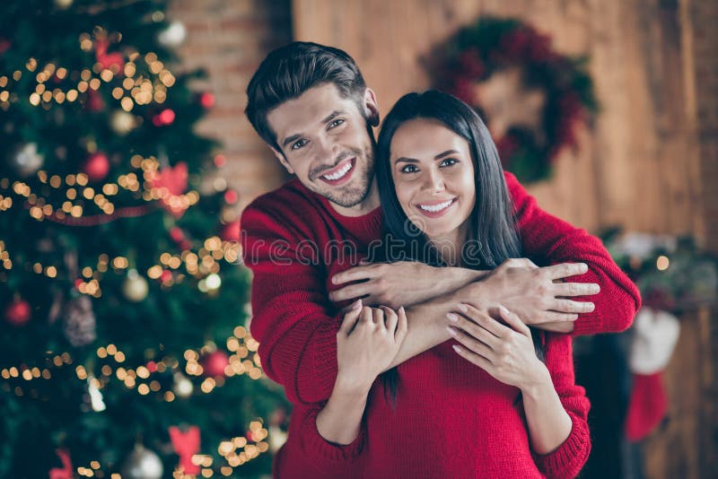 Portrait Of Two Romantic Lovely People Hug Near Christmas Tree In The