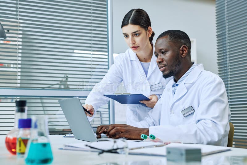 Two Scientists Using Laptop Doing Research in Laboratory Stock Image ...