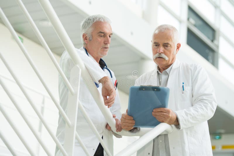 Portrait Two Senior Doctors Talking Stock Image - Image of exam ...