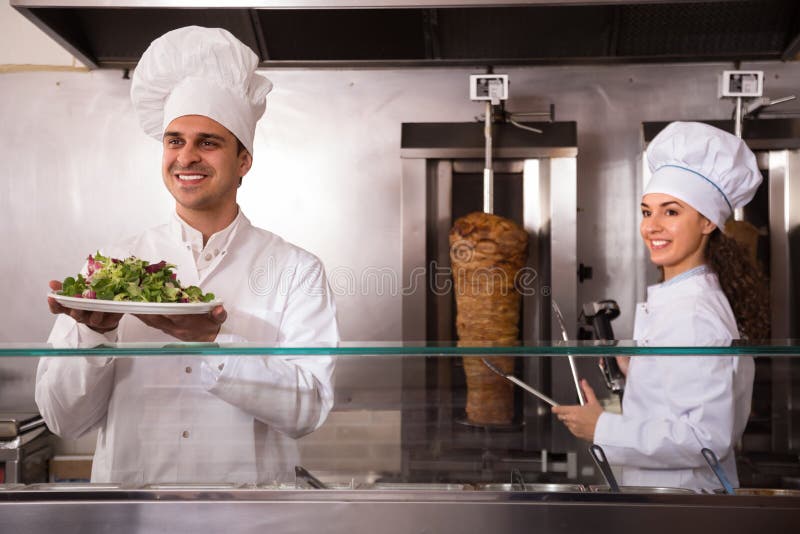 Two Smiling Chefs in Kitchen. Couple in Love with Perfect Food. Man and ...