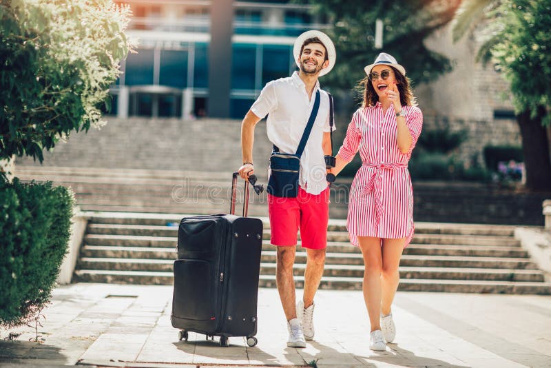 Two Smiling Young Tourists Walking in Town Stock Photo - Image of ...
