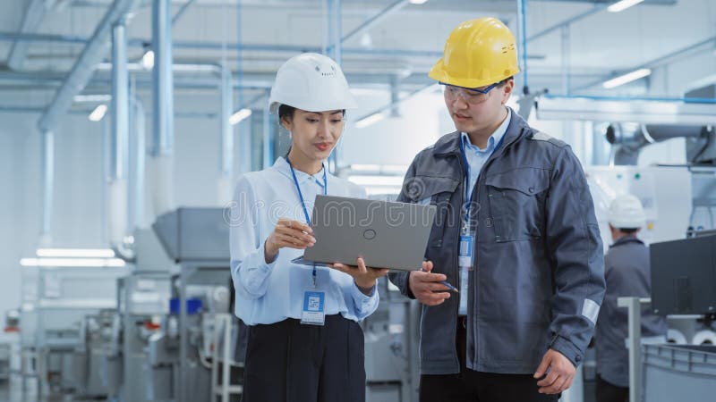 Portrait of Two Young Asian Heavy Industry Engineers in Hard Hats ...